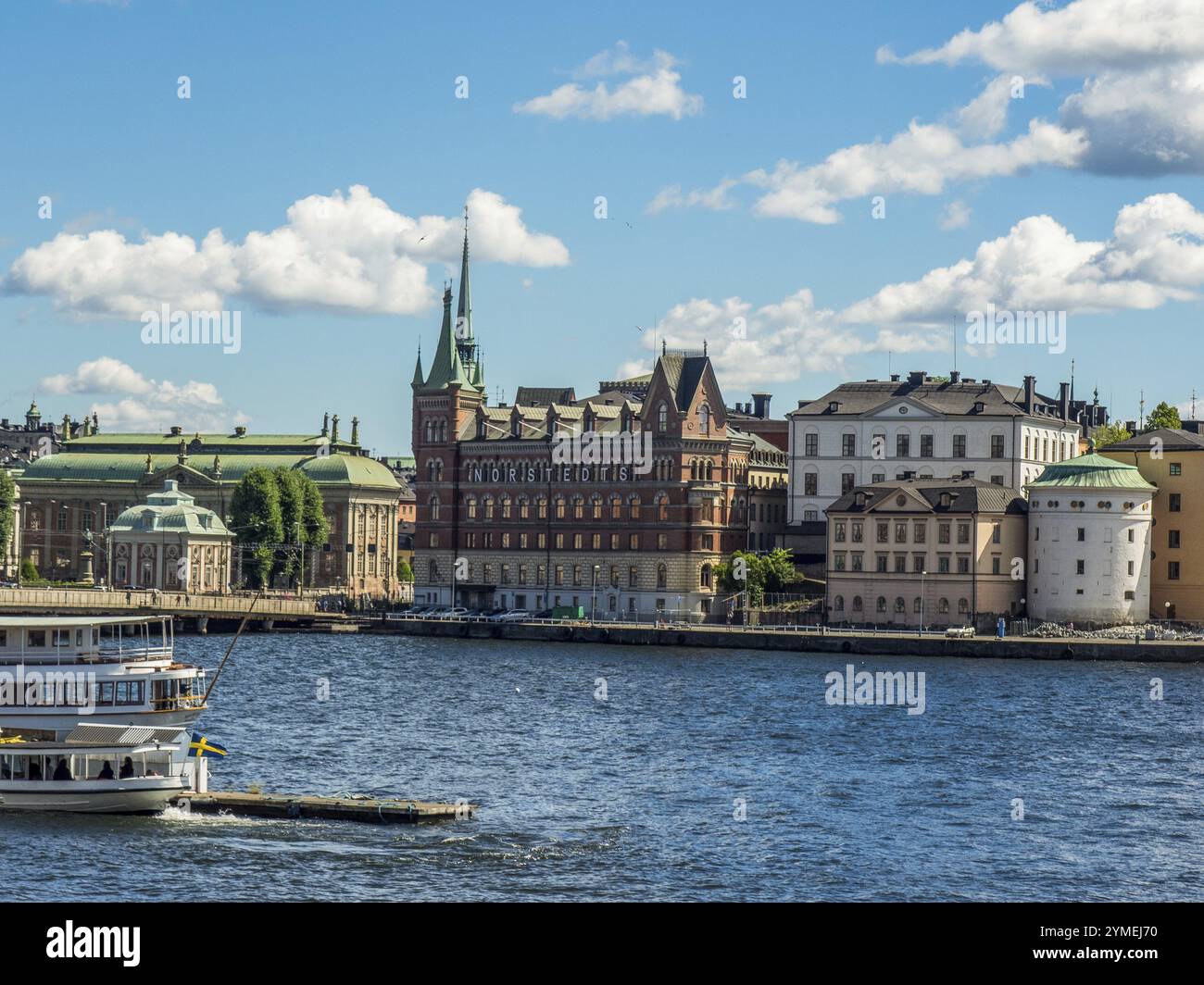 View of historic buildings on the waterfront under a blue sky with ...