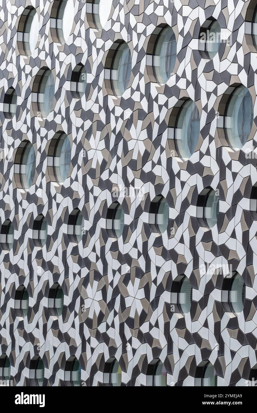 Facade with a repetitive geometric design and circular windows creating a modern look, London ...