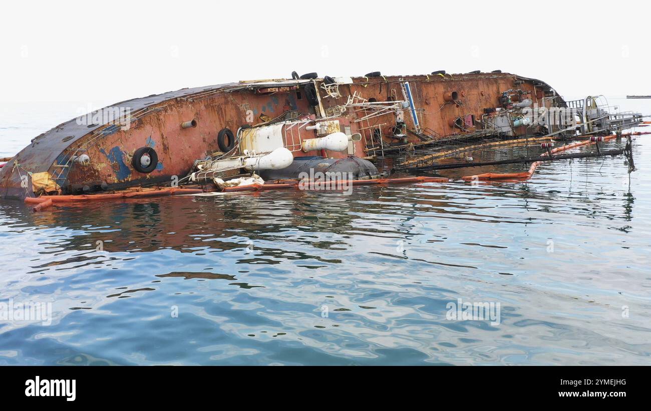 Broken rusty oil tanker ship in the shallow water. Sunken drowned ship ...