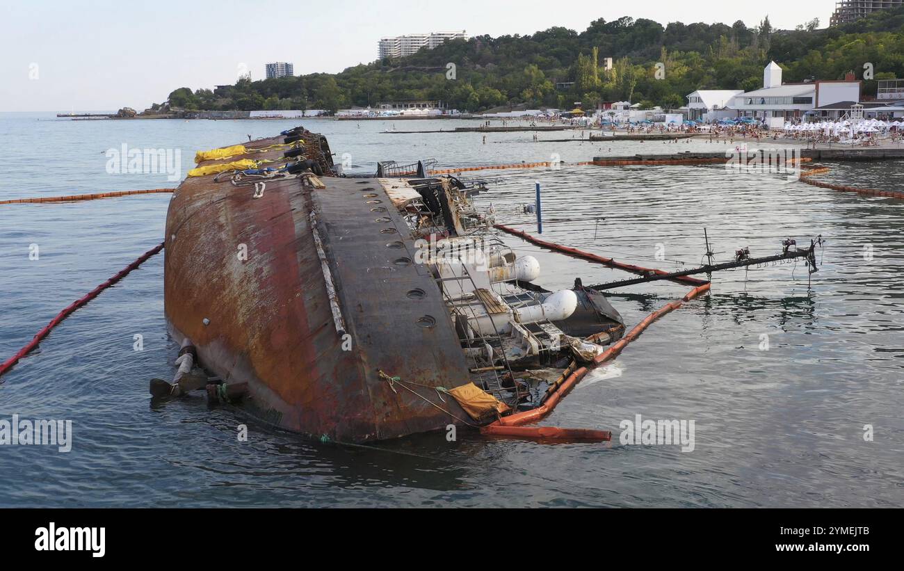 Overturned rusty oil tanker ship in the shallow water. Drowned sunken ...