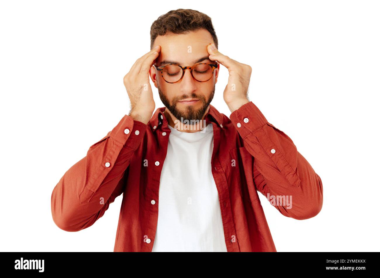 Focused caucasian or arabian man holding his temples with his hands ...
