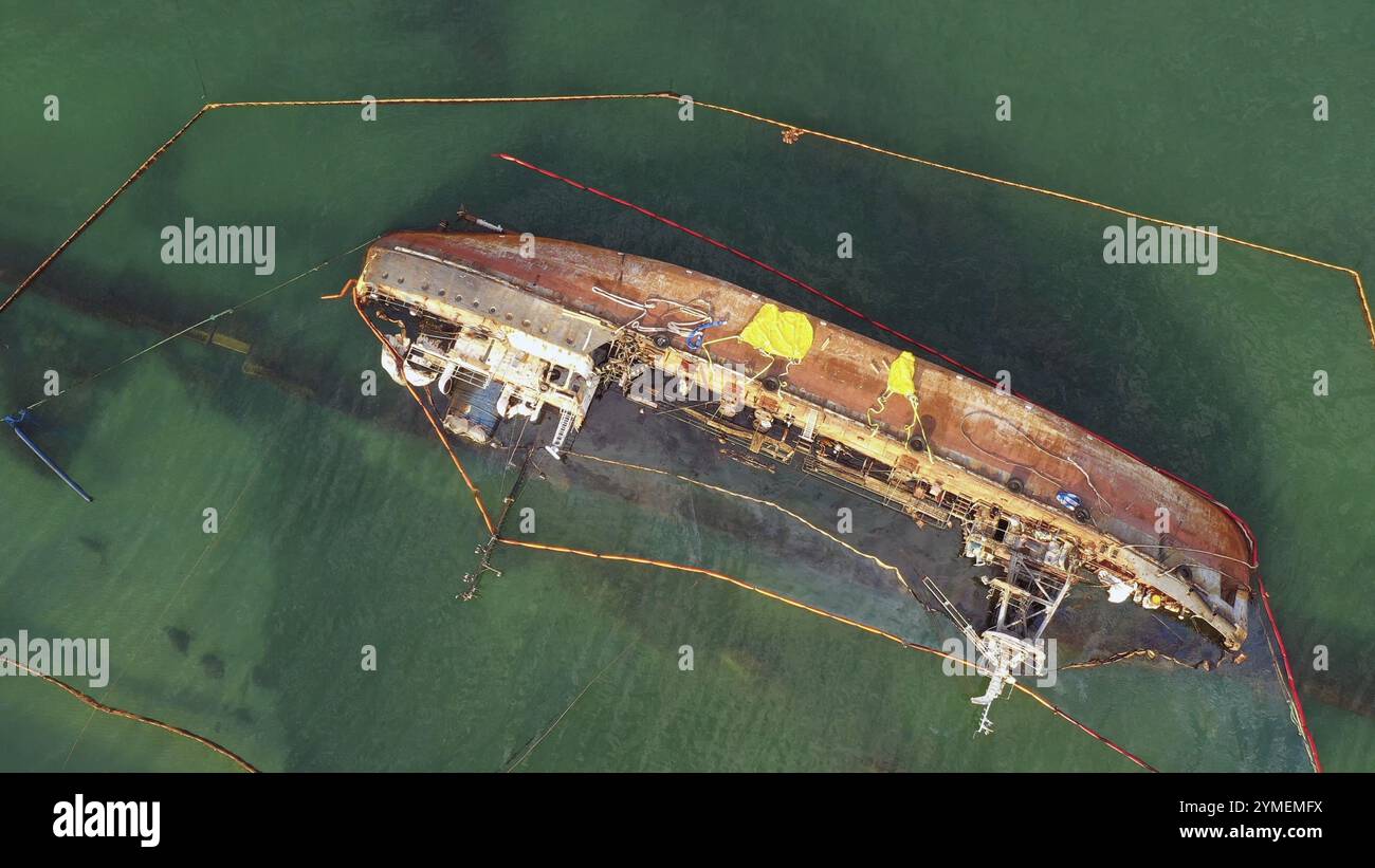 Aerial top view of overturned broken rusty oil tanker ship in the ...