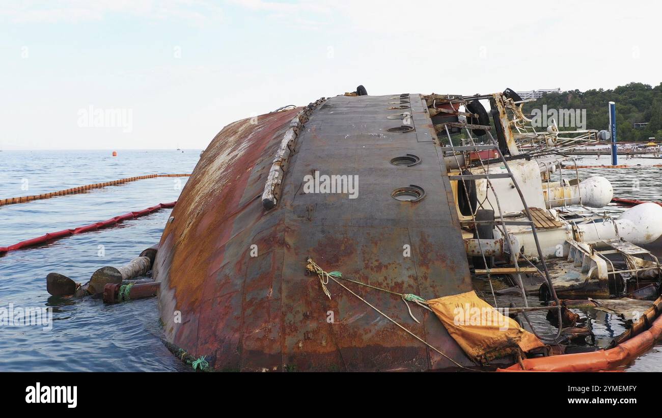 Close up of overturned rusty oil tanker ship in the shallow water ...