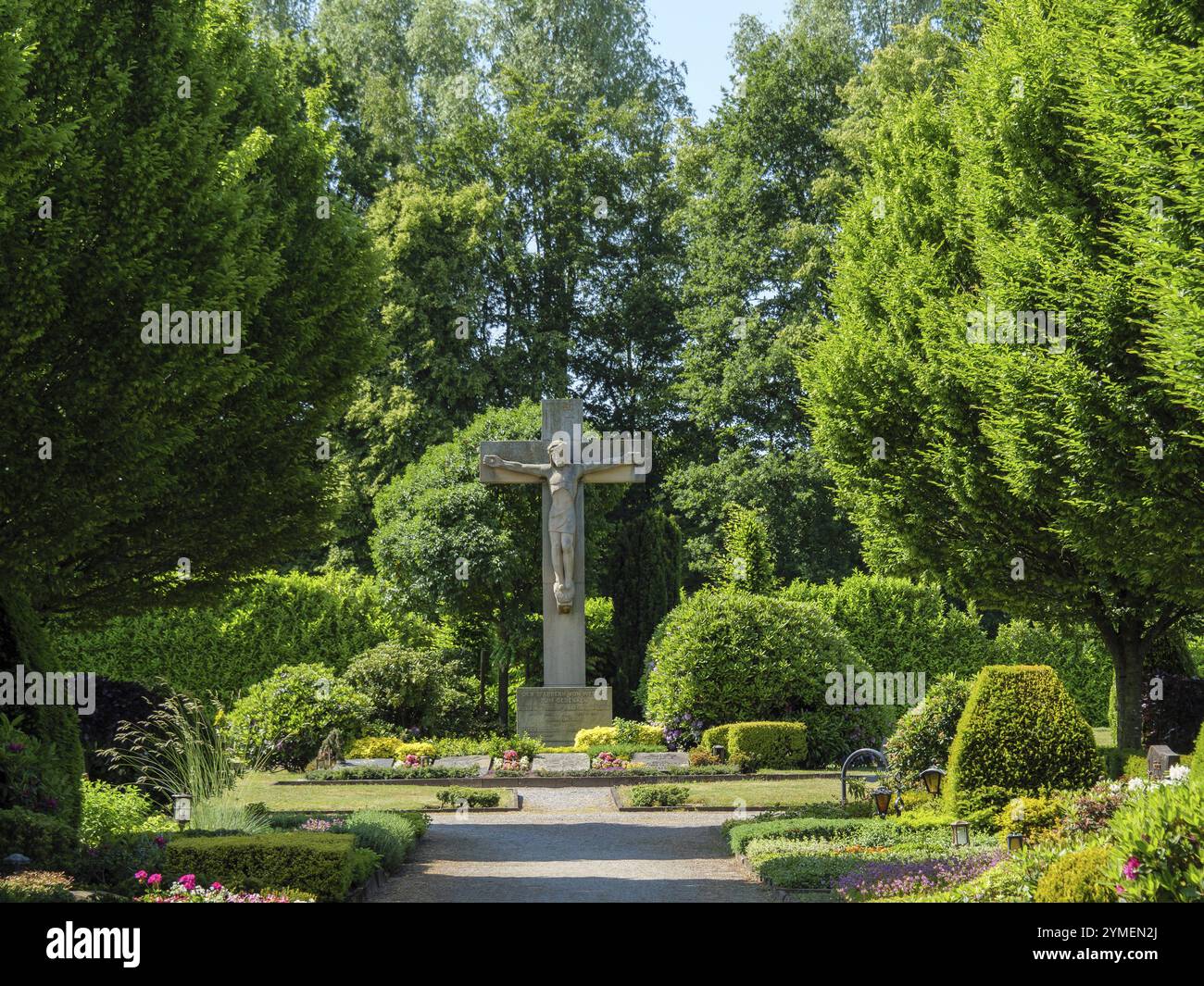 Jesus figure on the cross in a peaceful, green cemetery, weseke ...