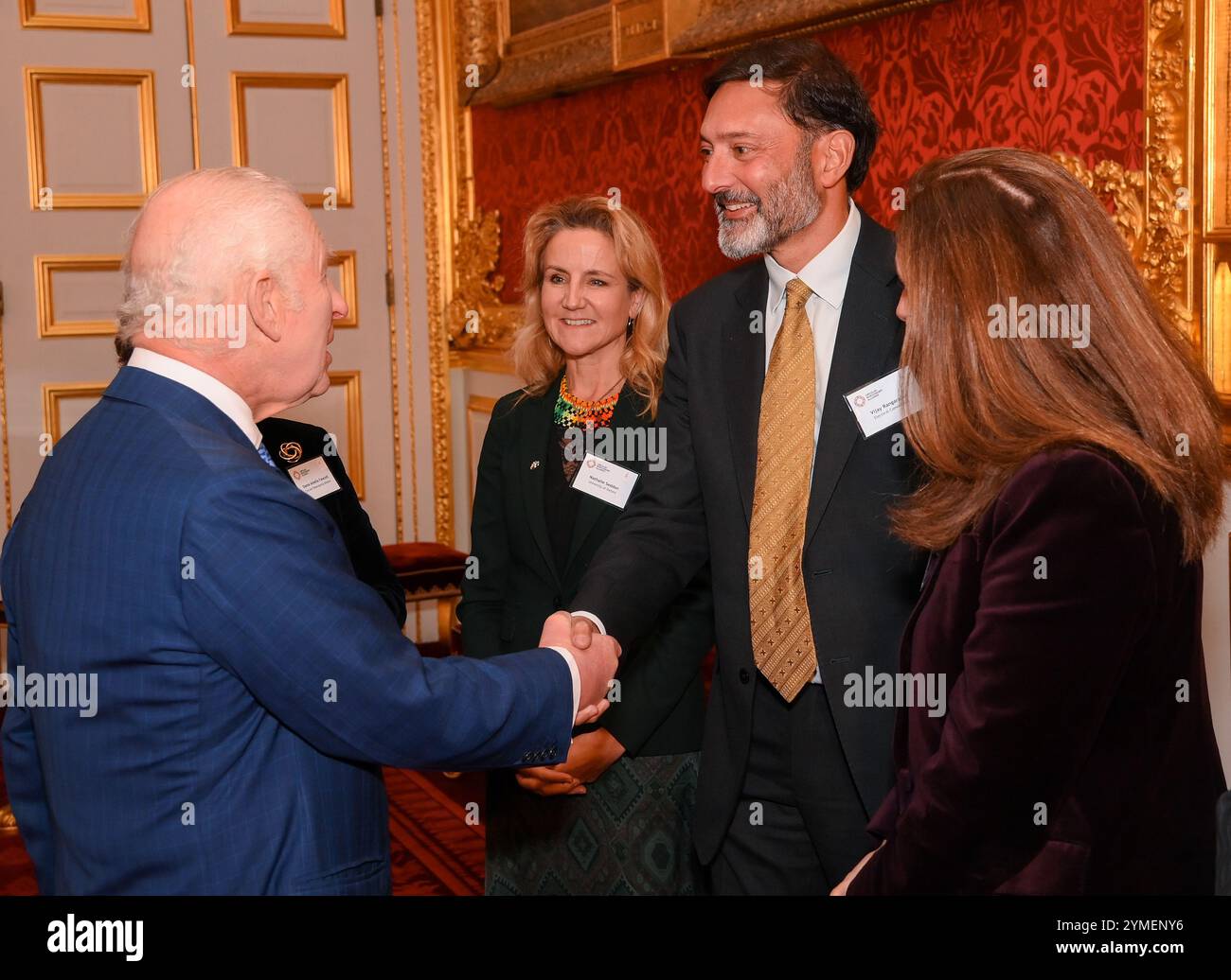 King Charles III shakes hands with Vijay Rangarajan as he joins ...