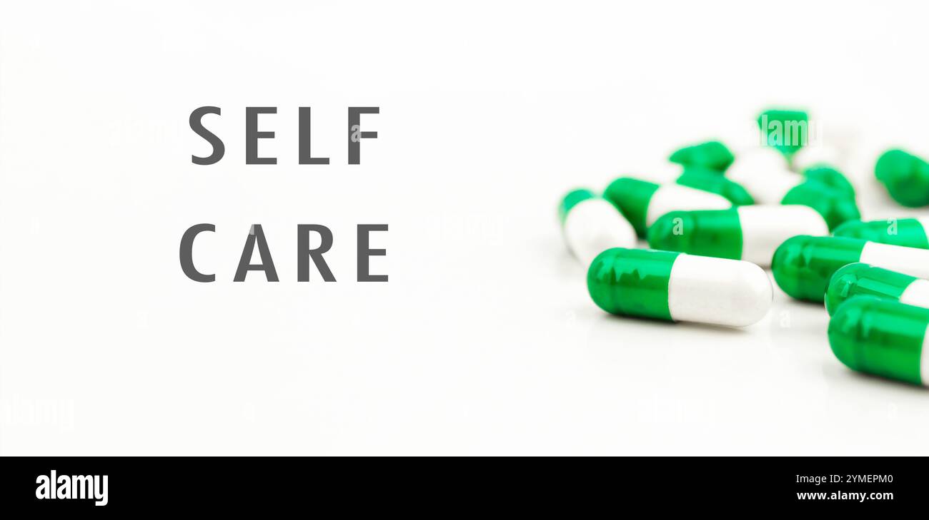 Bunch of pills with the word self care written below them Stock Photo ...