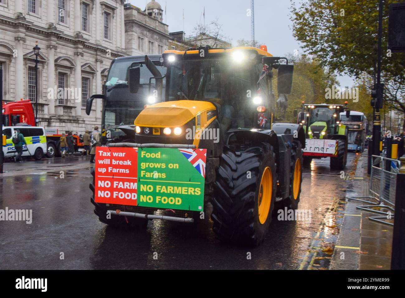 London, UK. 19th November 2024. Tractors pass through Whitehall as ...