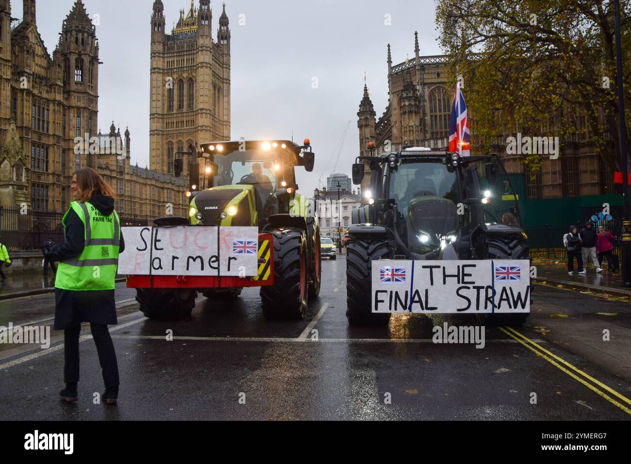 London, UK. 19th November 2024. Tractors pass through Parliament Square ...