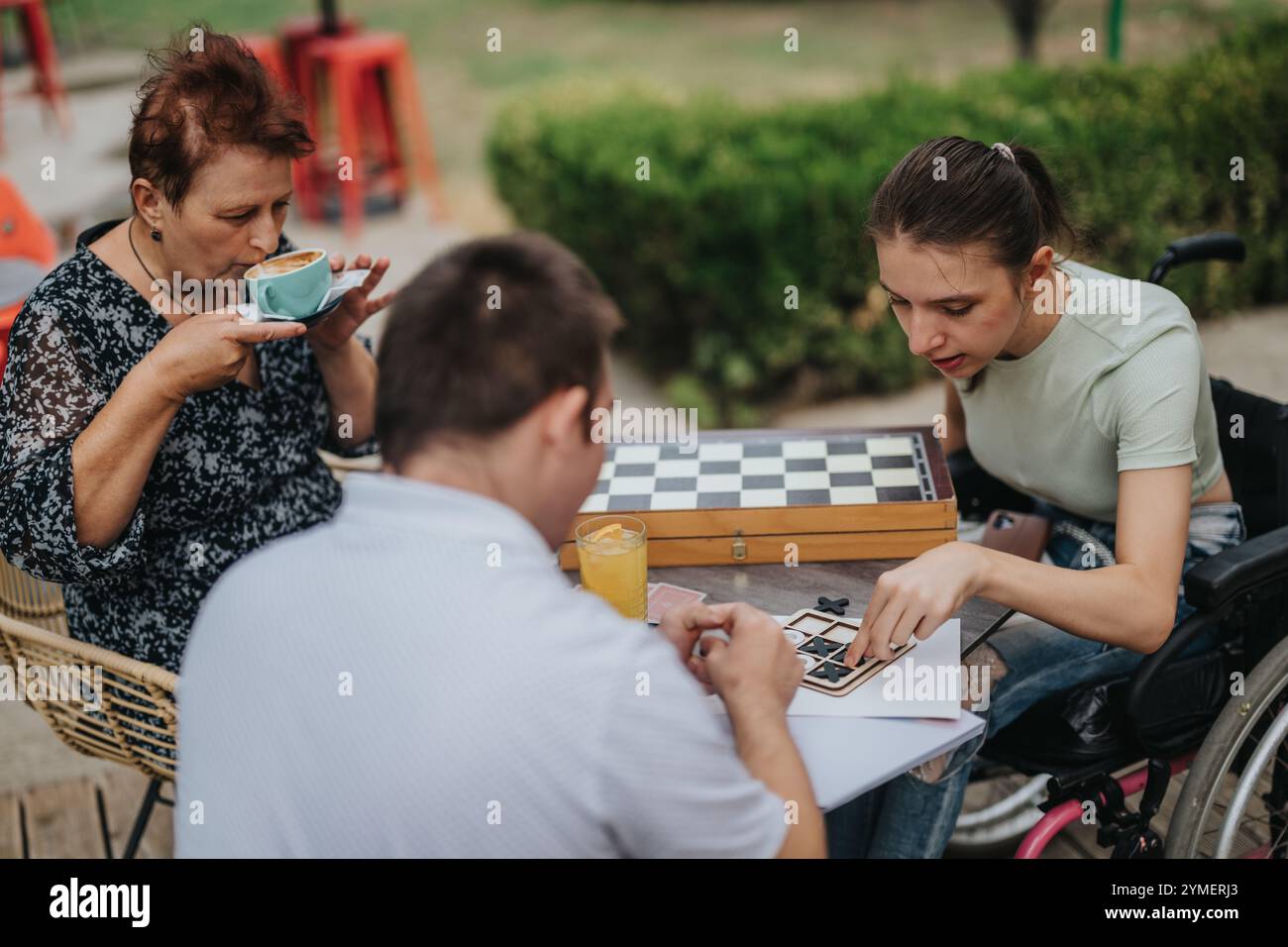 Family bonding over a fun card game outdoors together Stock Photo - Alamy