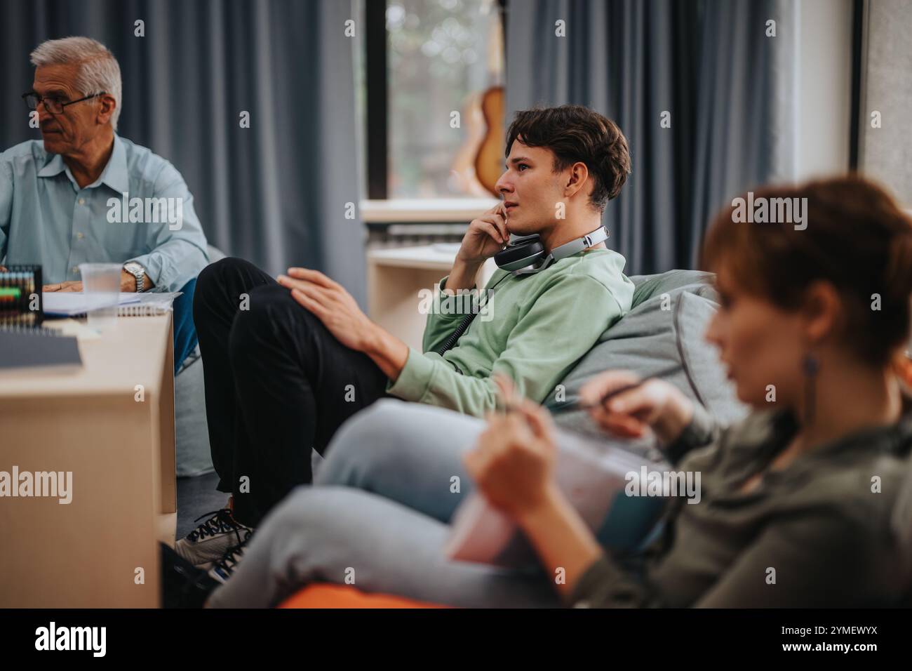 Professor discussing with students in a modern classroom setting Stock ...