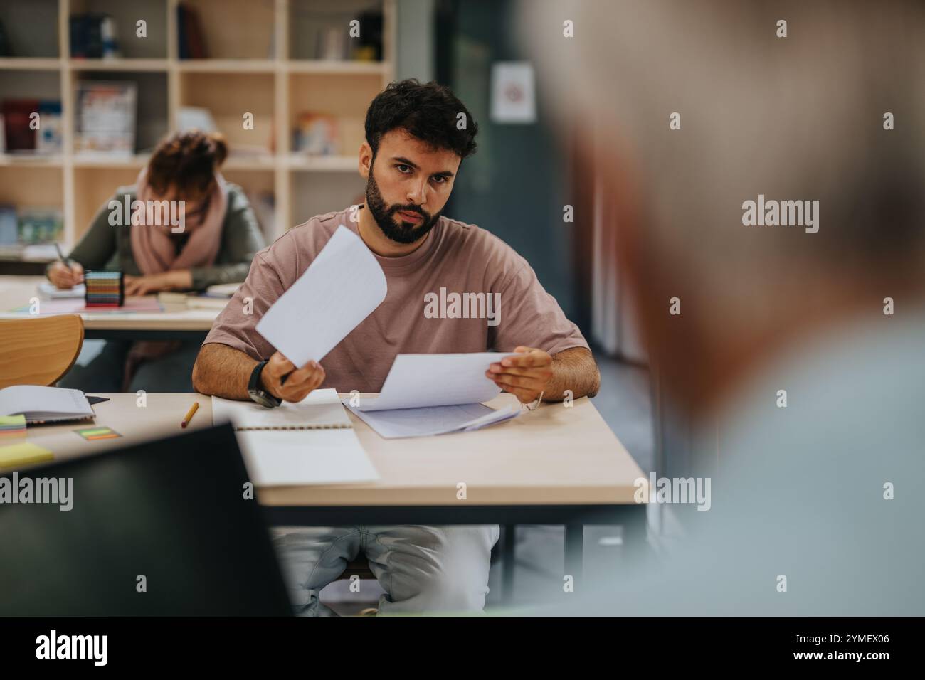 Attentive students focused in a cozy classroom setting Stock Photo - Alamy