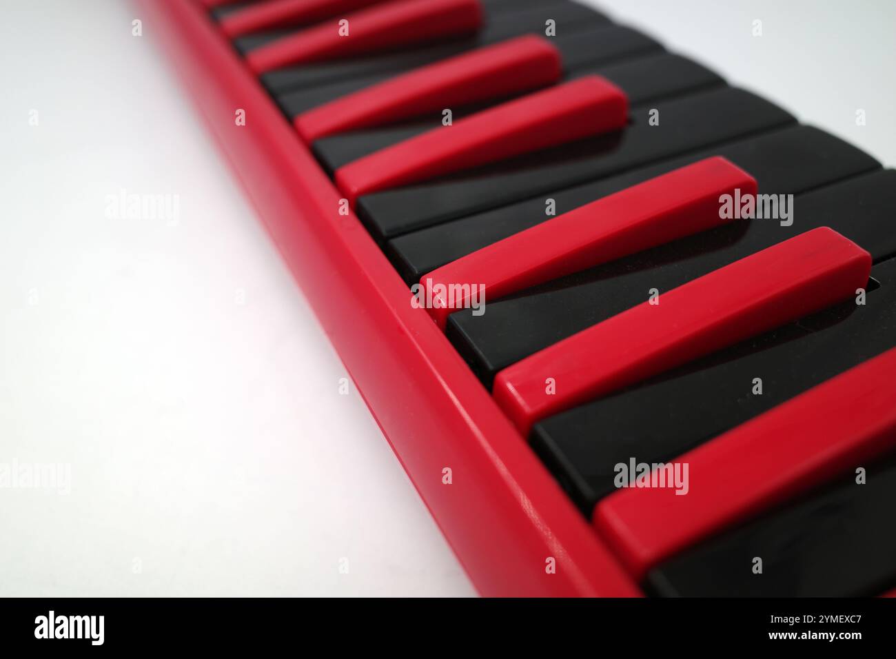 The keys of a black and red melodica. A melodica is a musical ...