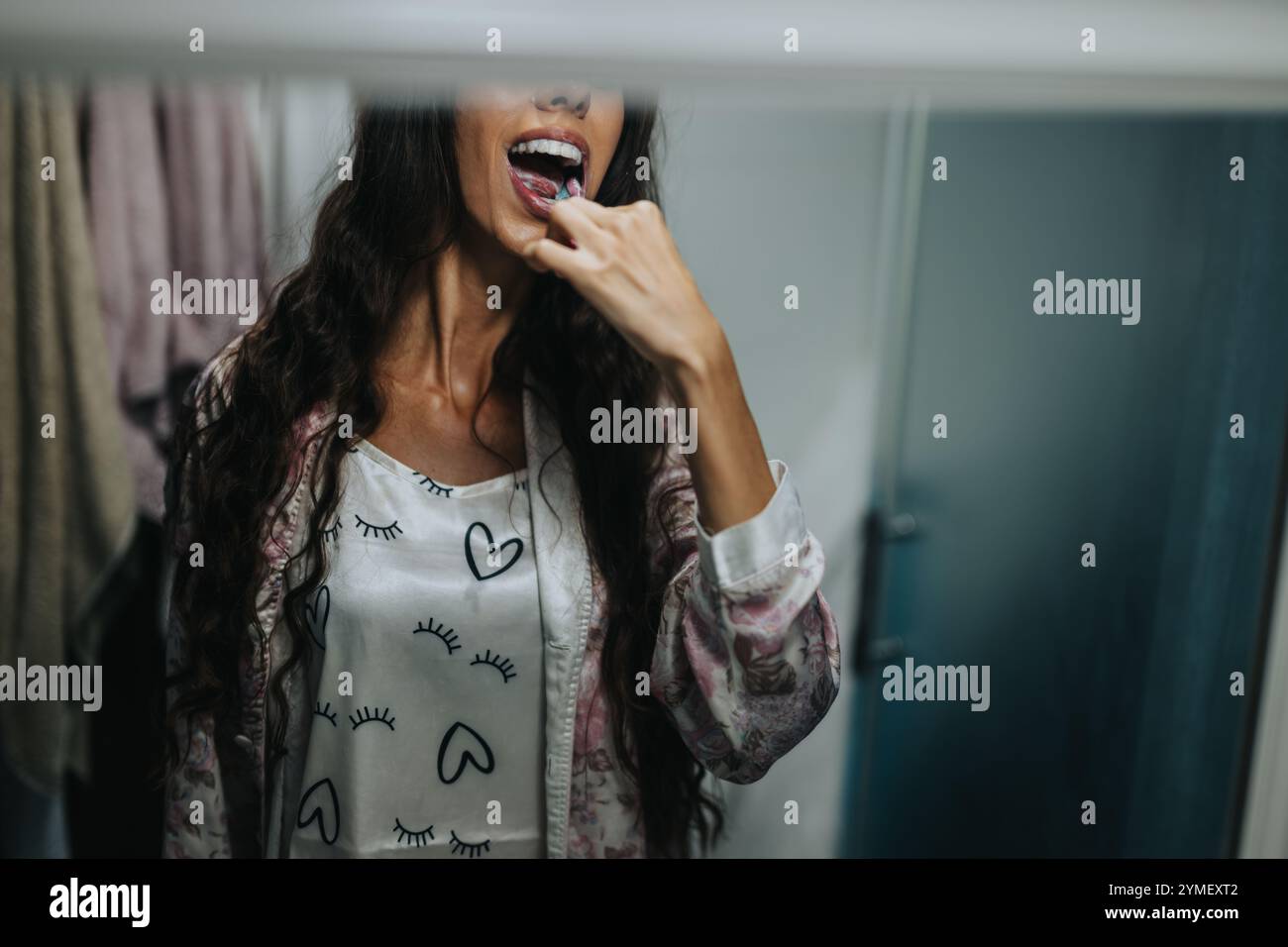 Woman brushing teeth in morning bathroom routine Stock Photo - Alamy