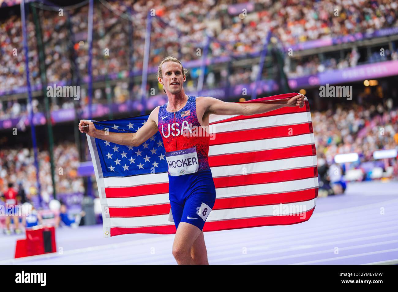 Cole Hocker celebrating her medal with her country's flag at the Paris ...