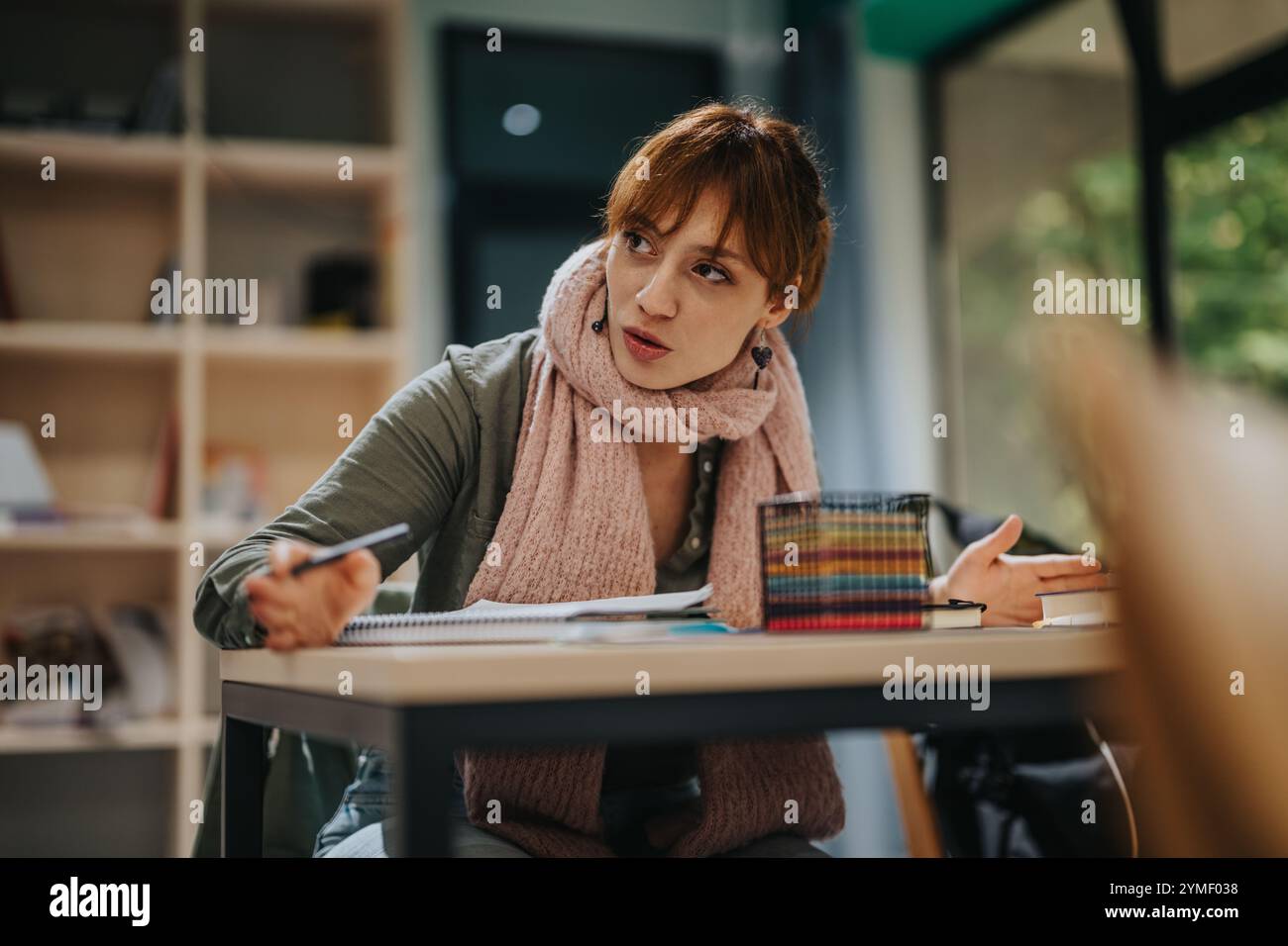Student engaging in discussion in a cozy classroom setting Stock Photo ...