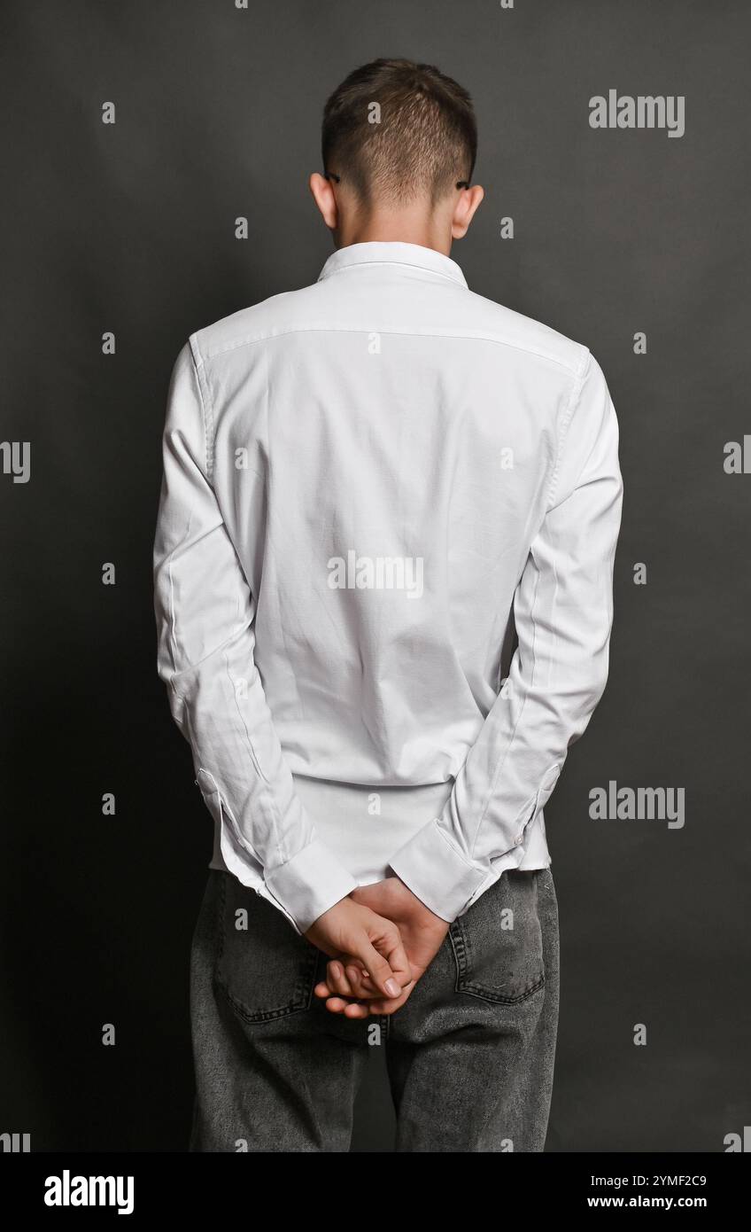 His hands are folded behind his back. vertical Stock Photo - Alamy