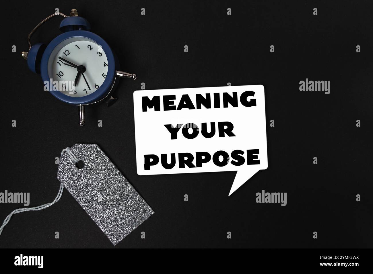 Blue alarm clock sits on a black background with the words Meaning Your ...