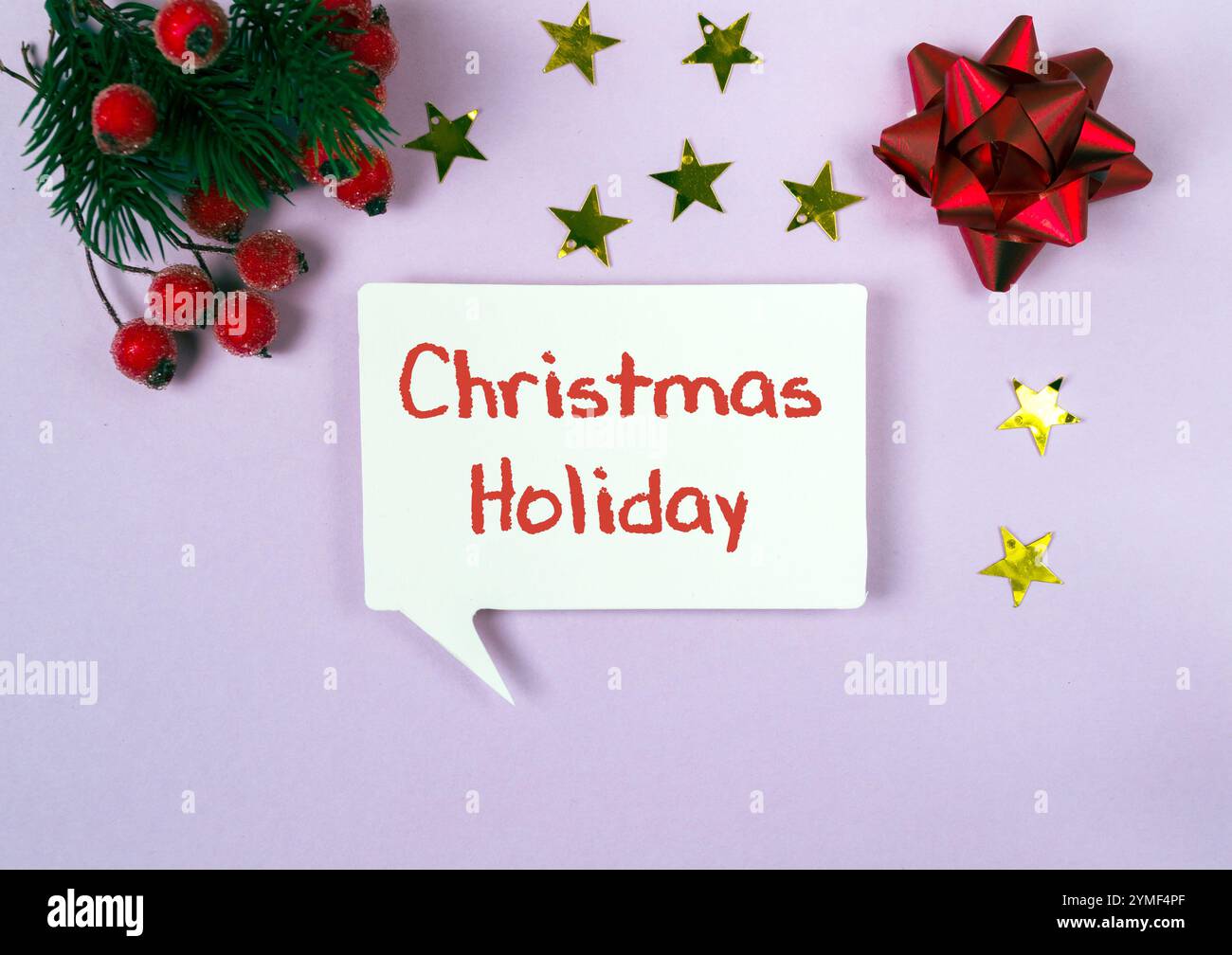 White sign with the words Christmas Holiday written on it. The sign is ...