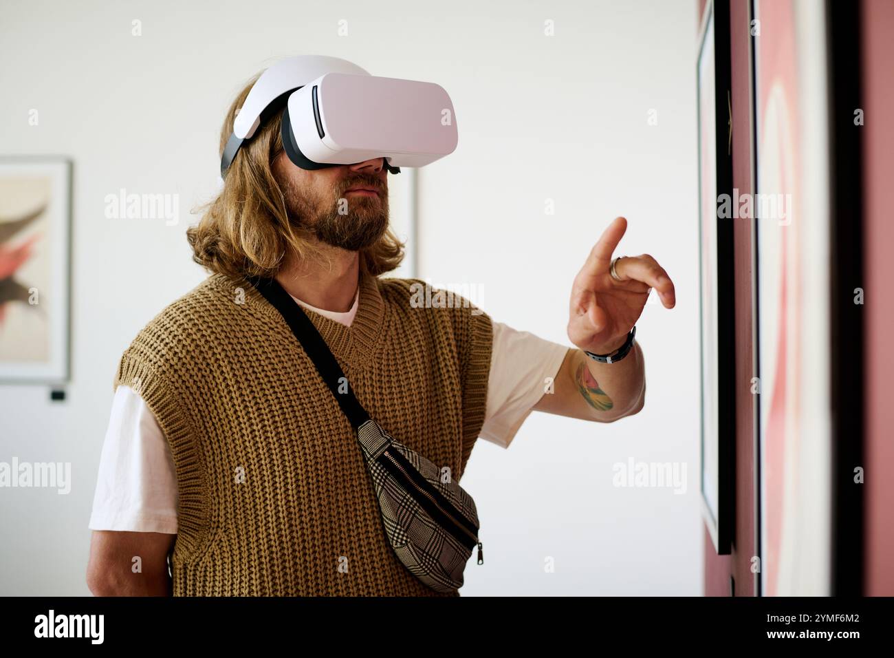 Man Engrossed In Virtual Reality Using Vr Headset With Finger Pointing At Unseen Object Wearing