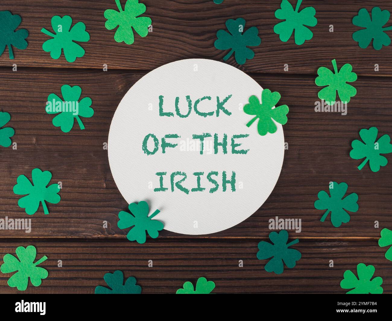 White circle with green clovers and the words Lucky of the Irish ...