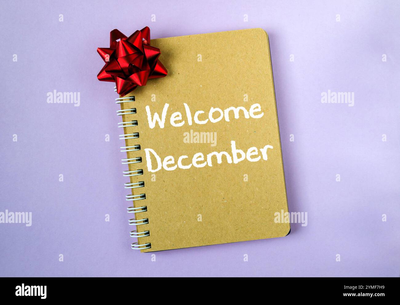 The words Welcome December are written on a notepad, evoking a warm and ...