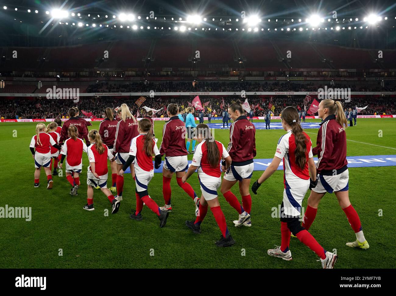 Arsenal players walk out with the mascots before the UEFA Women's ...