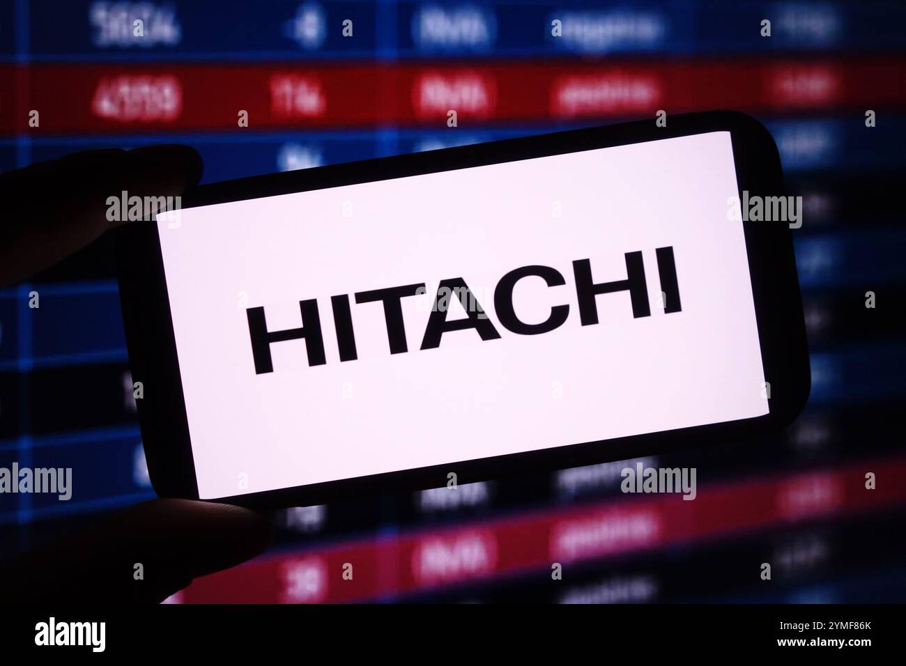 In this photo illustration, the Hitachi company logo is seen displayed ...
