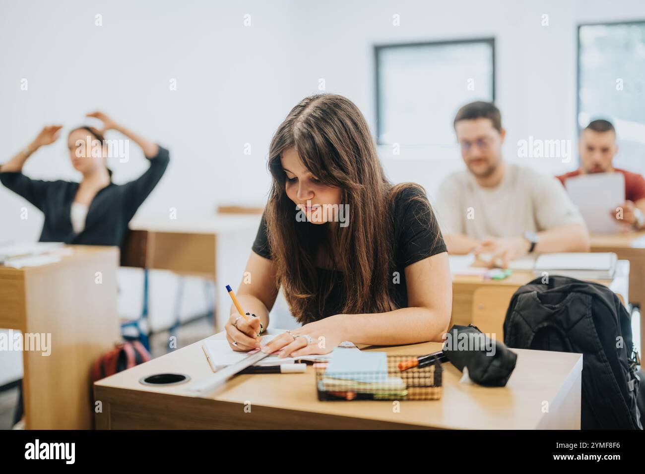 Focused high school students attentively studying in classroom setting ...
