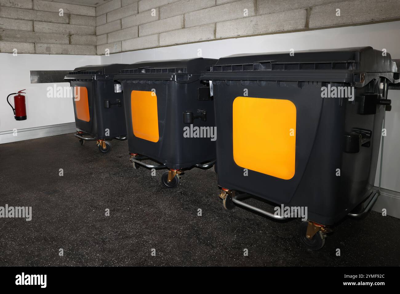 Plastic recycling containers in room Stock Photo - Alamy