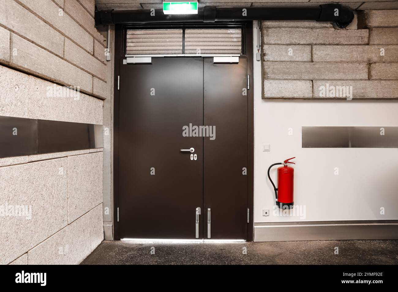 View of fire extinguisher and door in building Stock Photo - Alamy