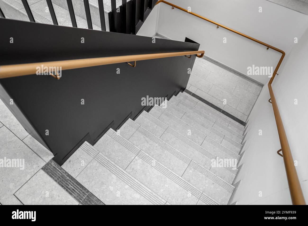 View of stairs with golden railing in modern building Stock Photo - Alamy