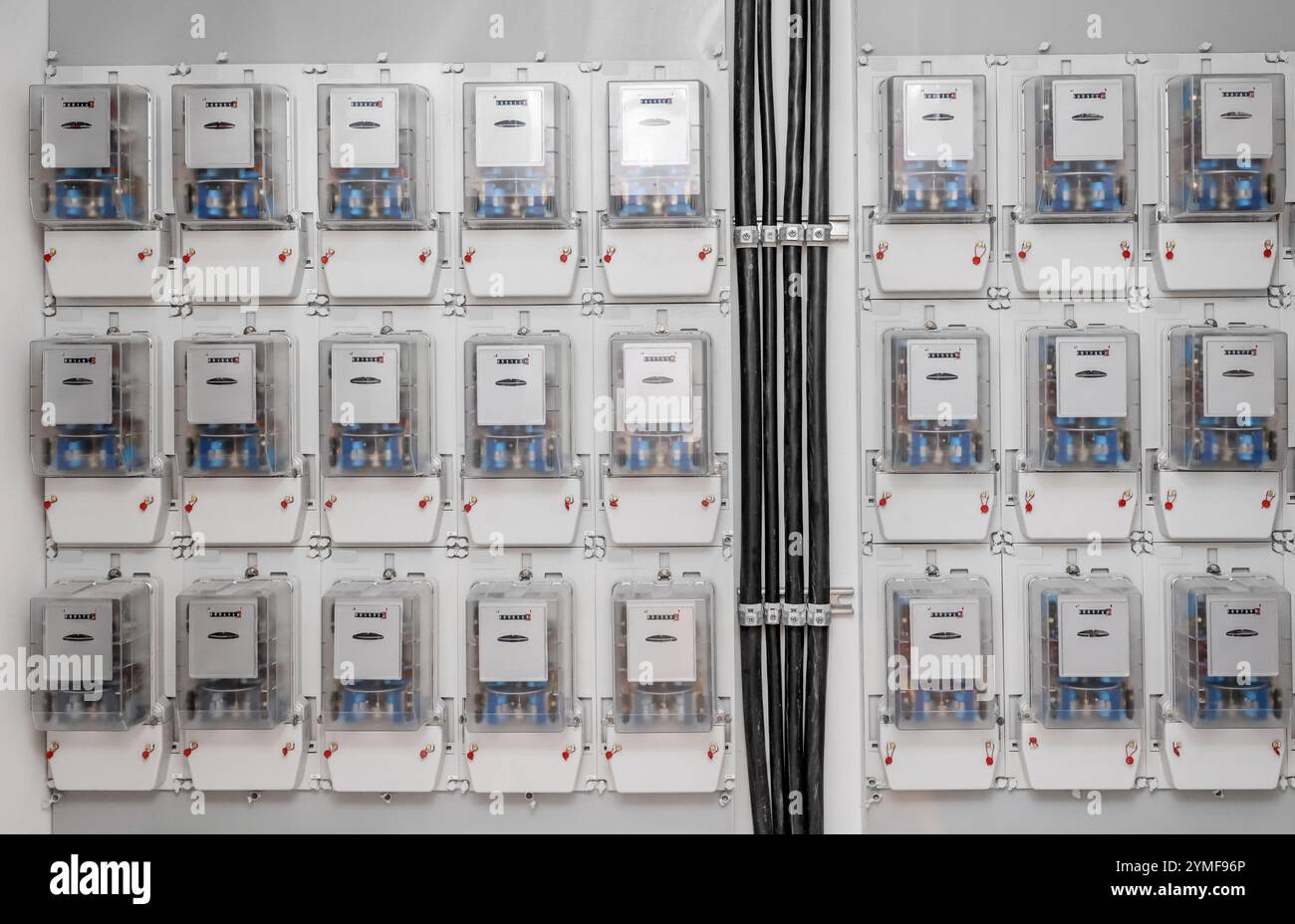 Electricity meters on light wall in room Stock Photo - Alamy