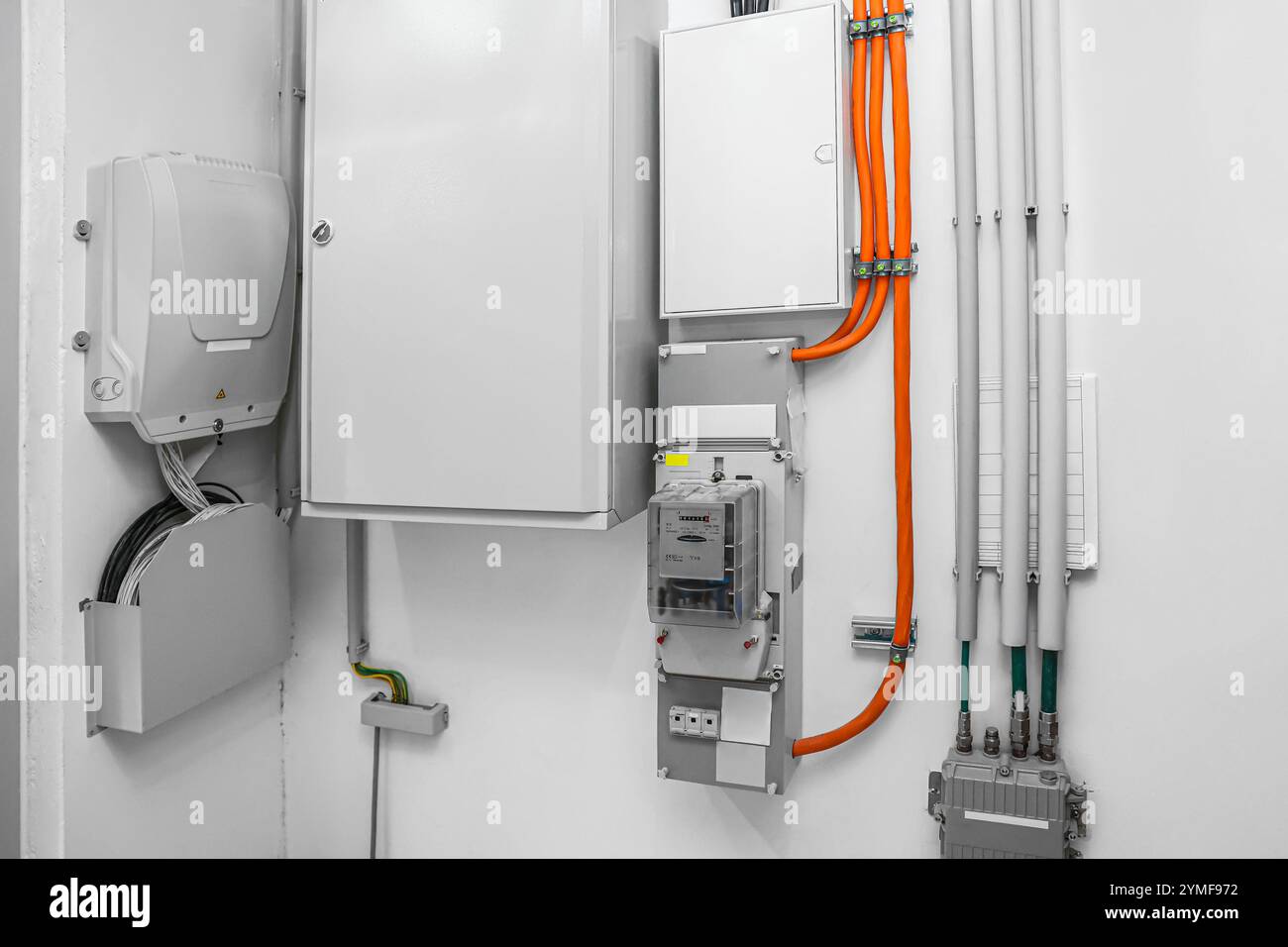Electricity meters and cabinet on light wall in room Stock Photo - Alamy