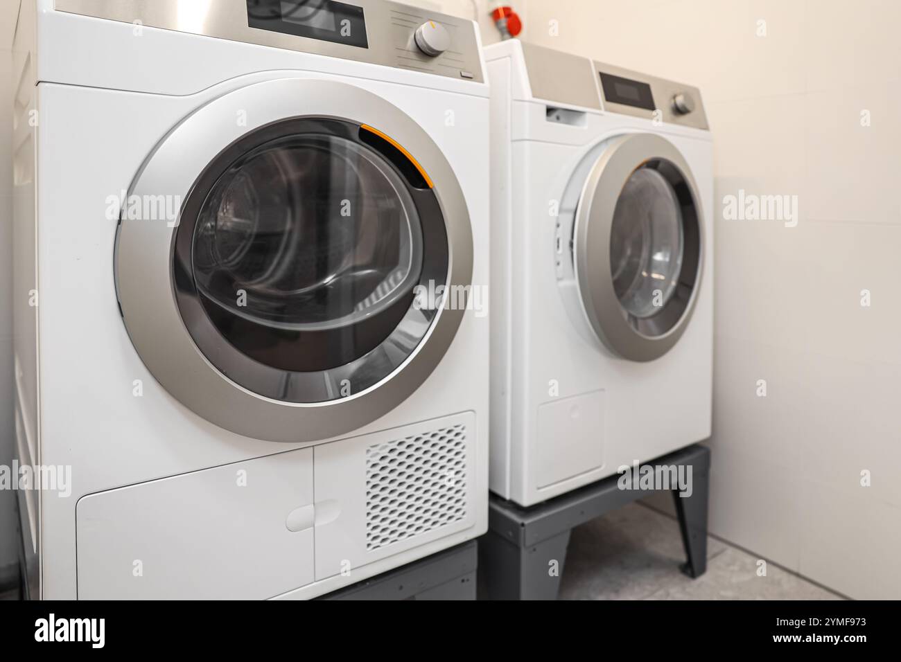 Modern washing machines in laundry room Stock Photo - Alamy