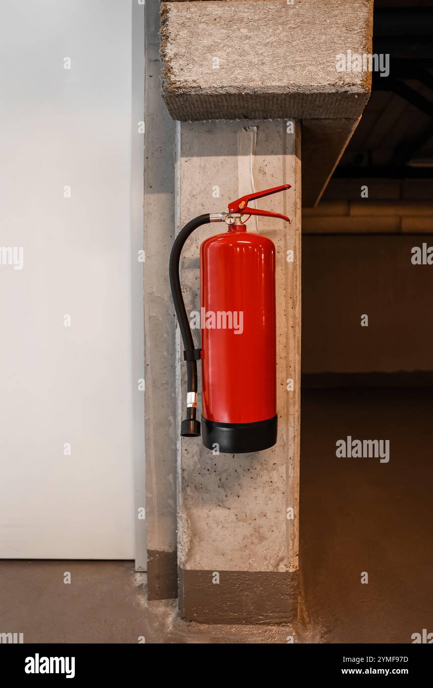Fire extinguisher hanging on wall in underground parking lot Stock ...