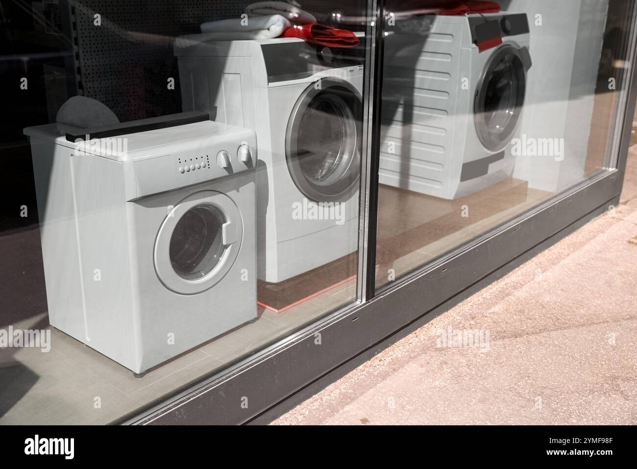 View of shop window with modern washing machines in store Stock Photo ...