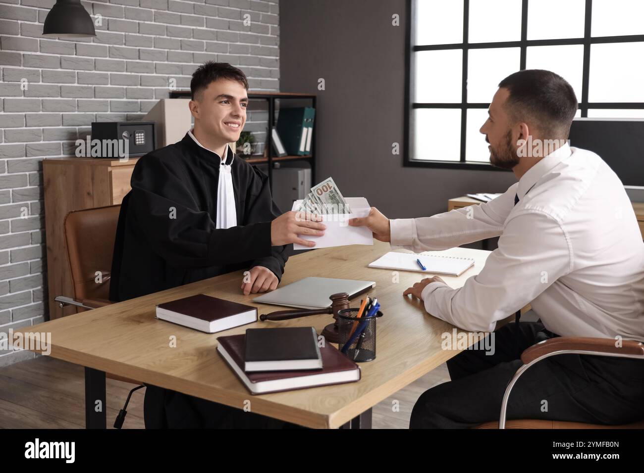 Male judge taking bribe from man at table in office. Corruption concept ...