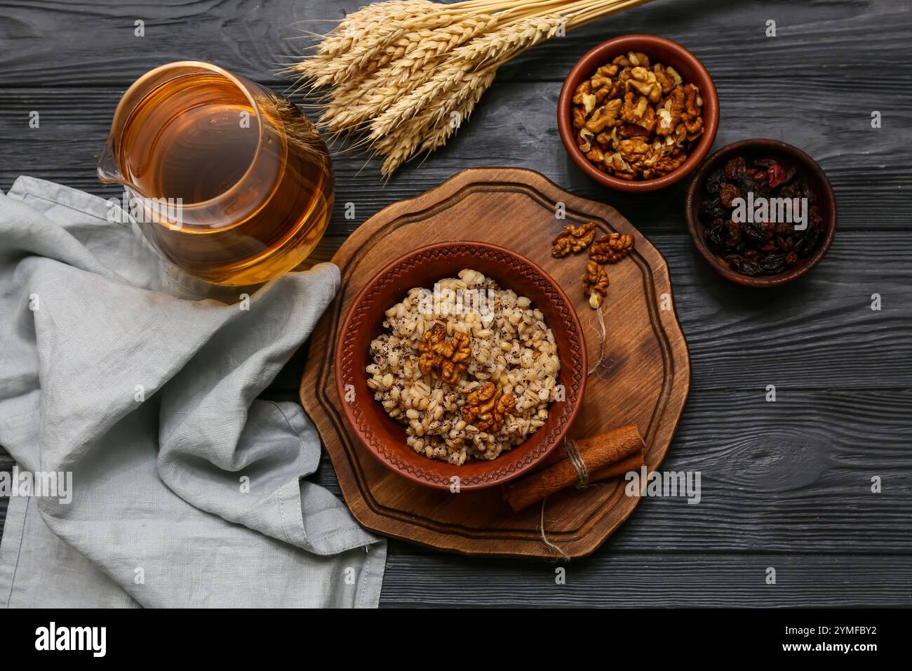 Bowl of traditional Ukrainian Kutya dish with walnut and jug of uzvar ...