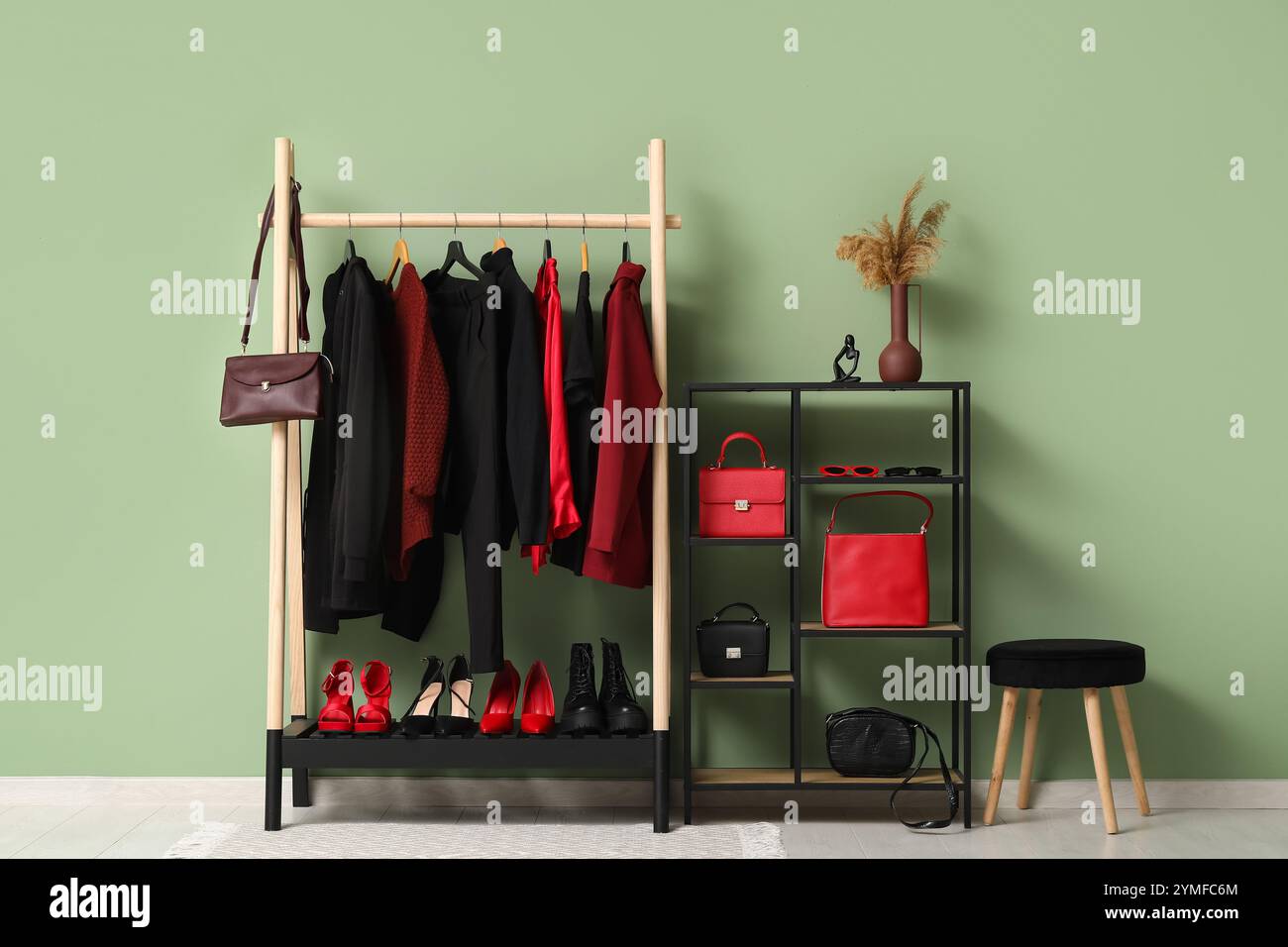 Racks with stylish female clothes, shoes and accessories near color ...