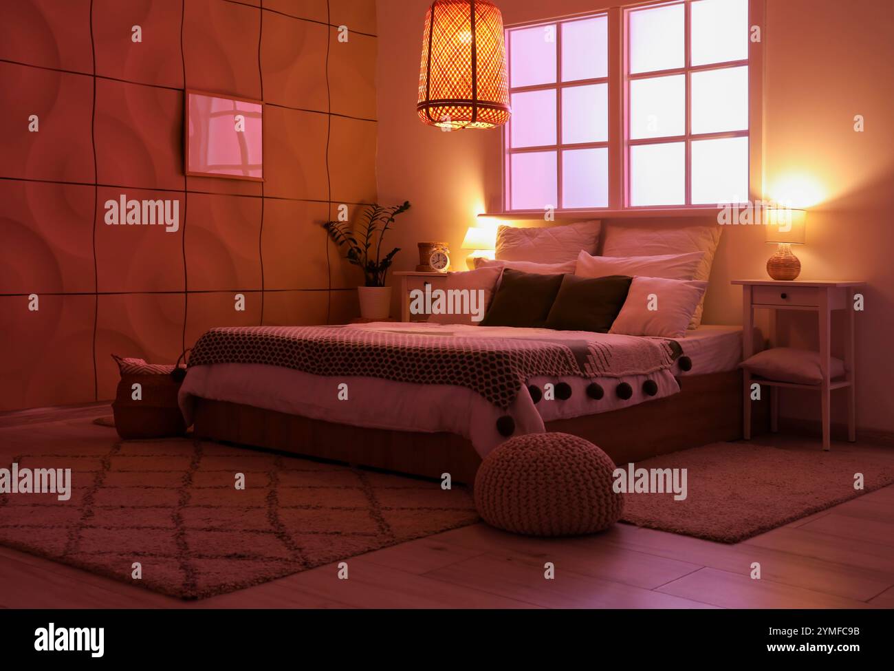 Interior of dark bedroom with window, tables and glowing lamps at night ...