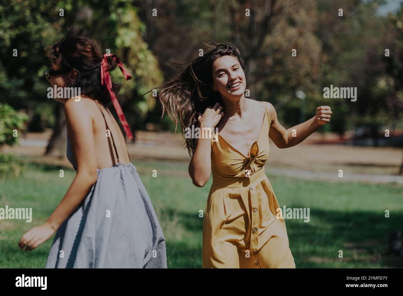 Two joyful friends enjoying a sunny day in the park, laughing and ...