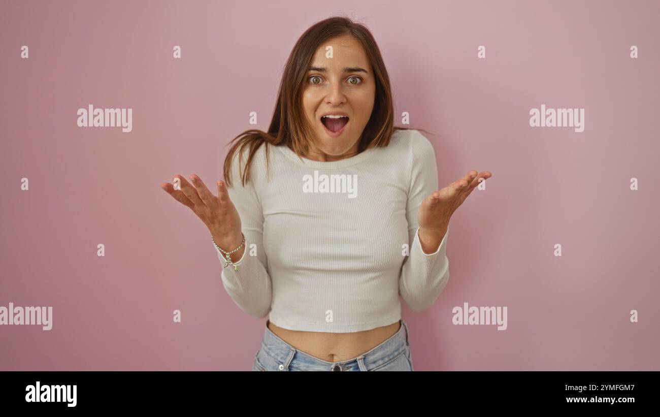 A young, attractive woman shows a surprised expression, isolated over a ...