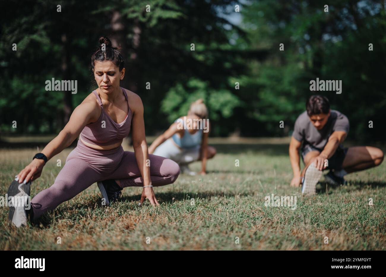 Group people performing stretching hi-res stock photography and images ...