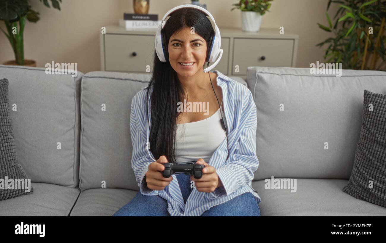 A young attractive hispanic woman playing a video game on the living ...