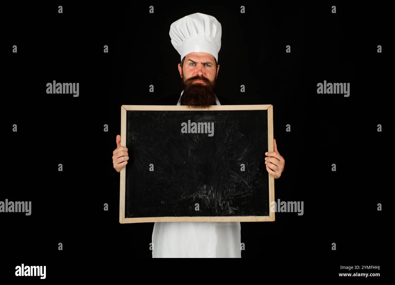Restaurant chef with blank chalkboard for business lunch menu with ...