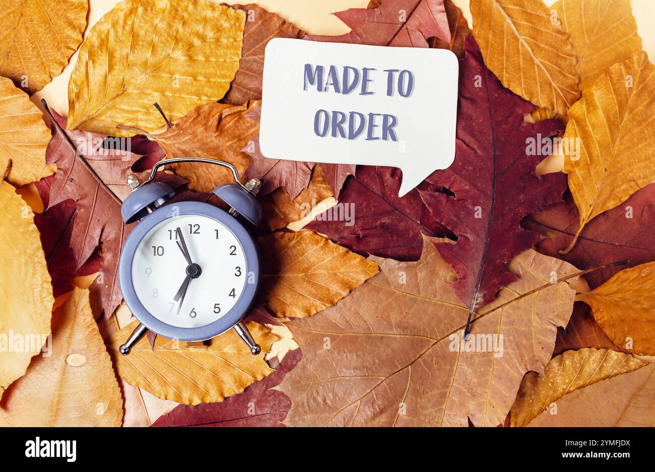 Clock is on top of a pile of leaves with the words Made to Order ...