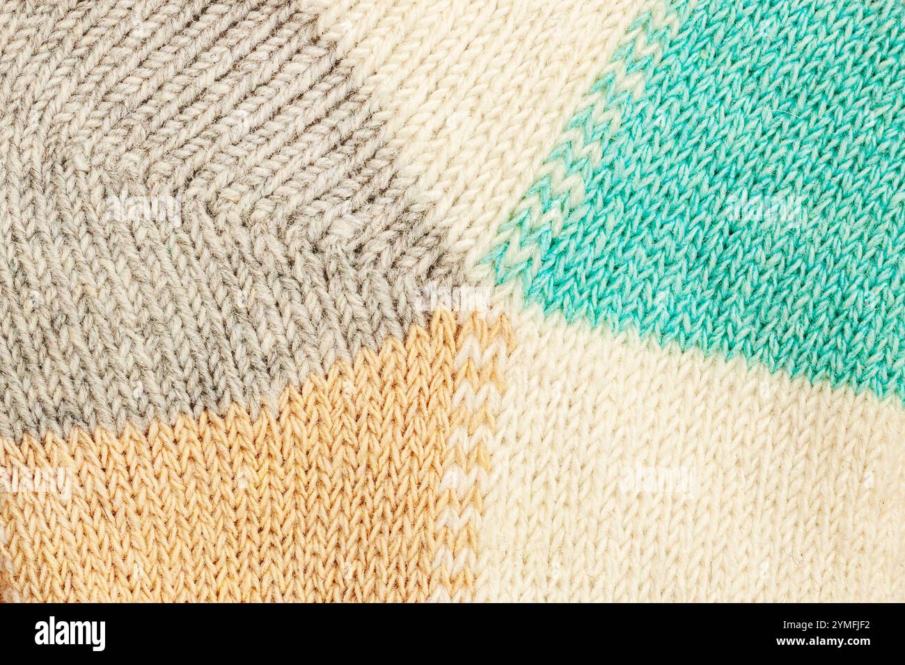 Knitted fabric texture with a mix of gray, beige, and turquoise ...