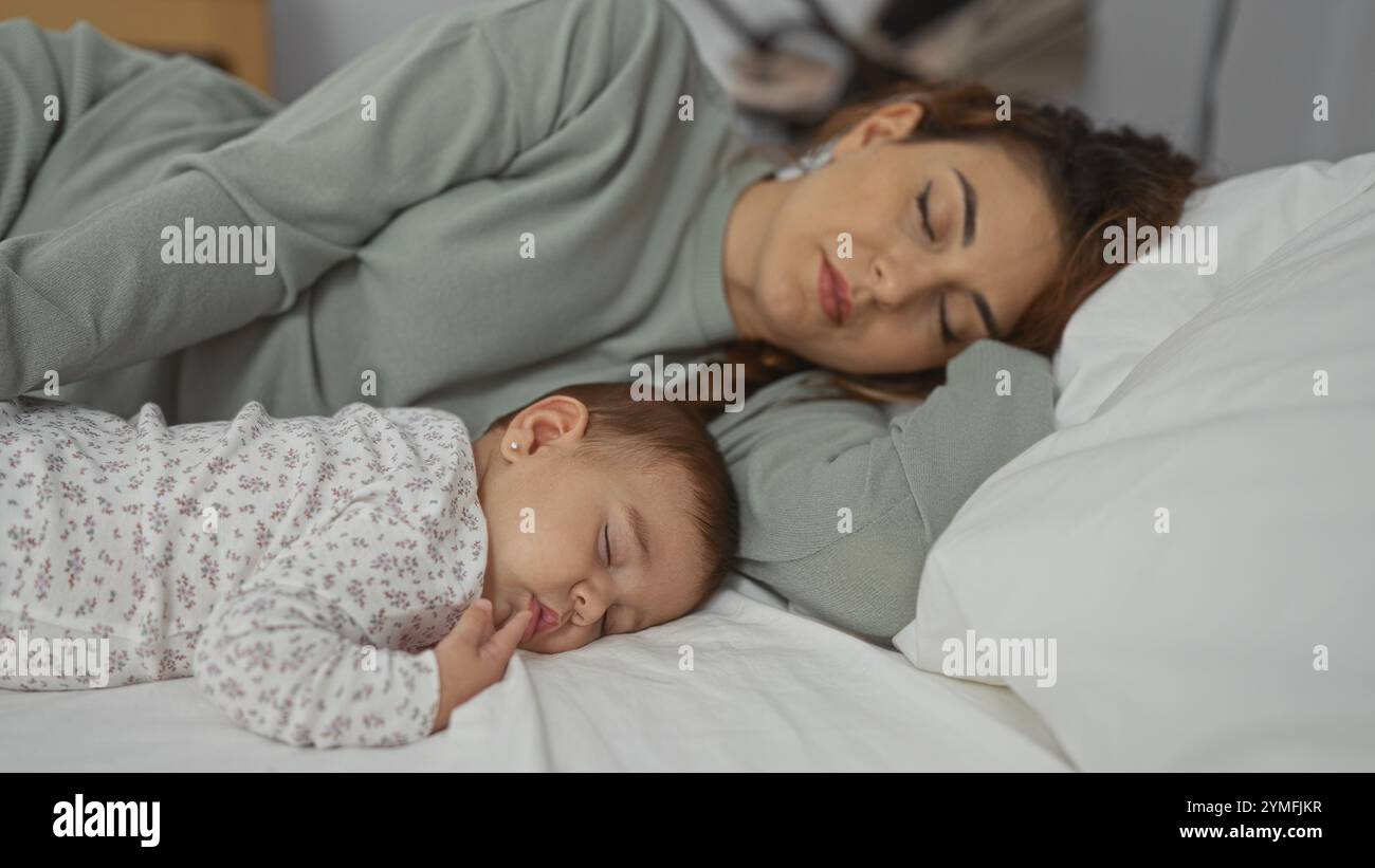 Mother and baby sleeping peacefully together in a cozy bedroom ...