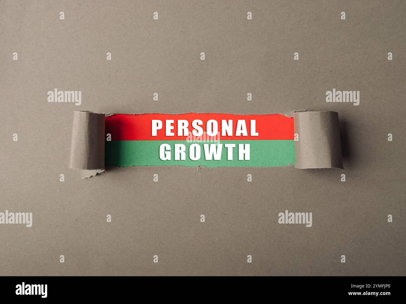 Torn piece of paper with the words personal growth written on it. The ...