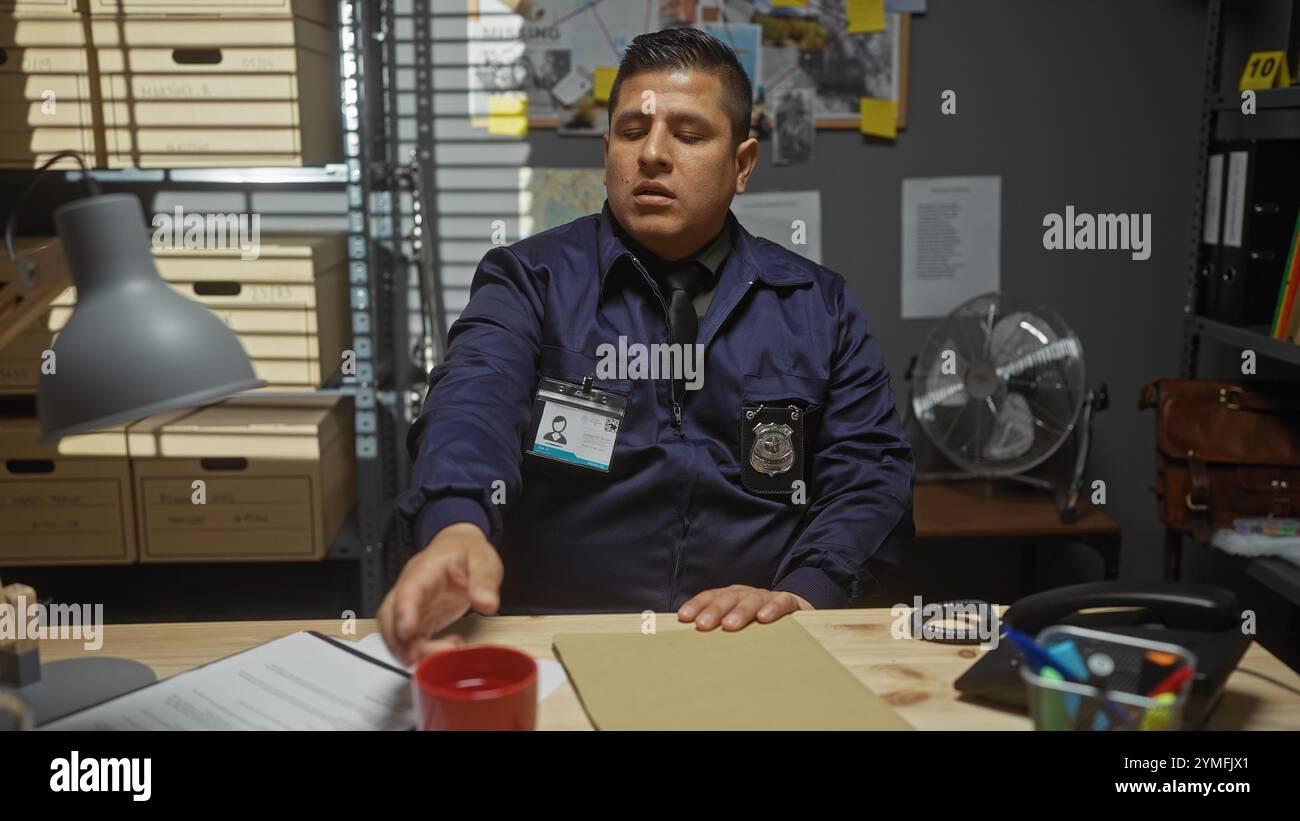 Hispanic detective man in uniform sitting indoors at police station ...